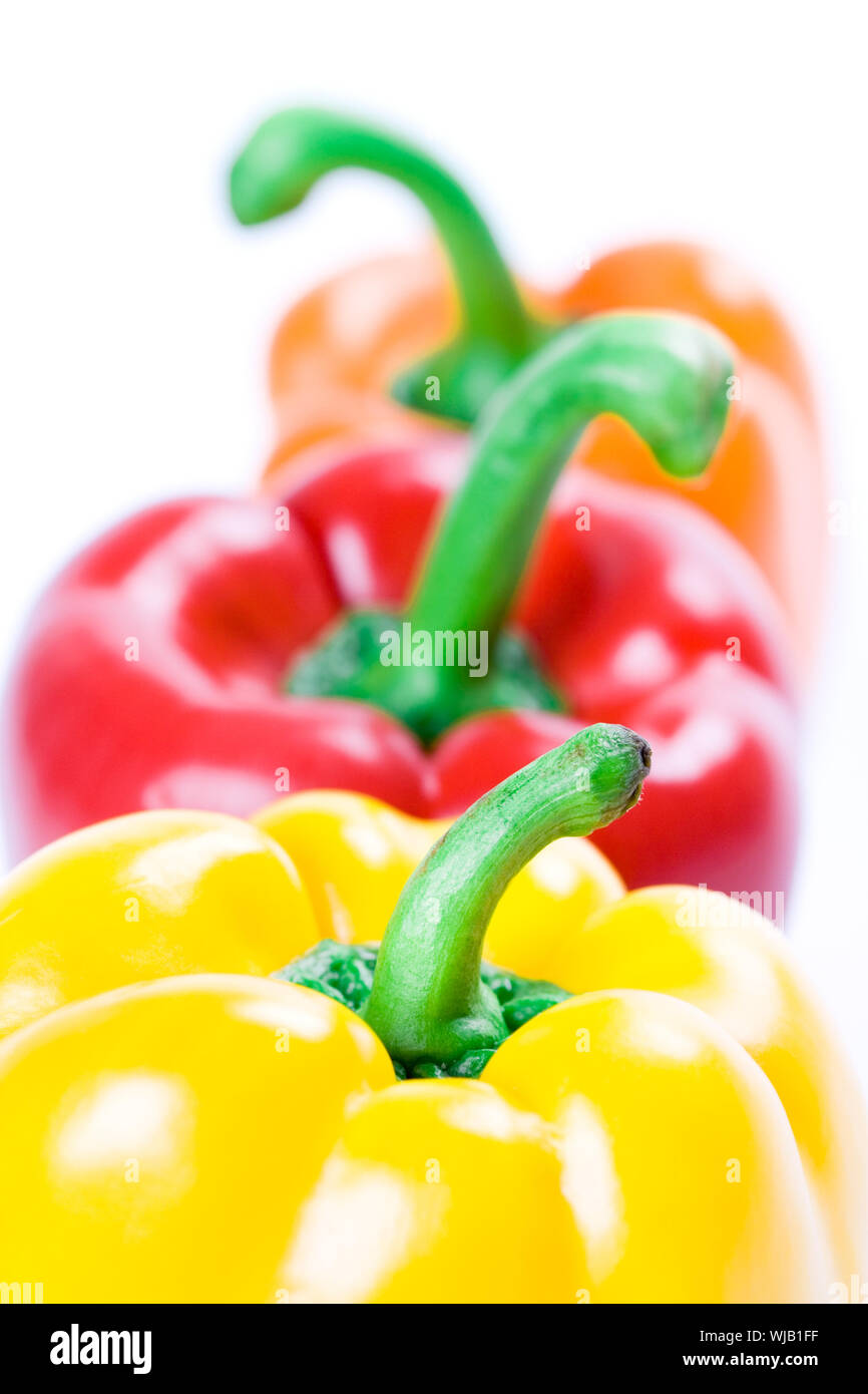 three bell peppers closeup on white background Stock Photo - Alamy