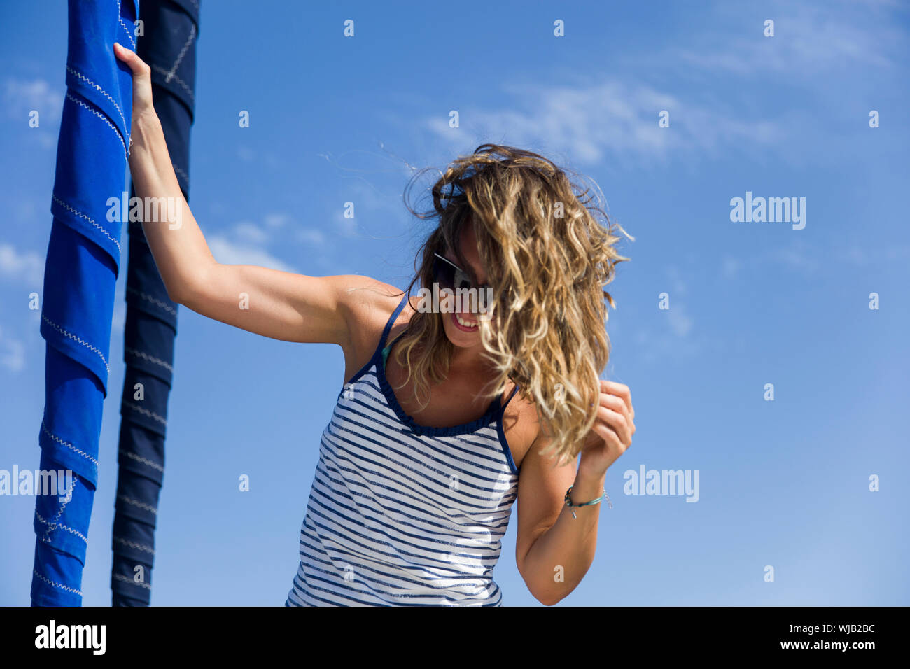 Attractive woman holding rope during sailing on luxury yacht Stock ...