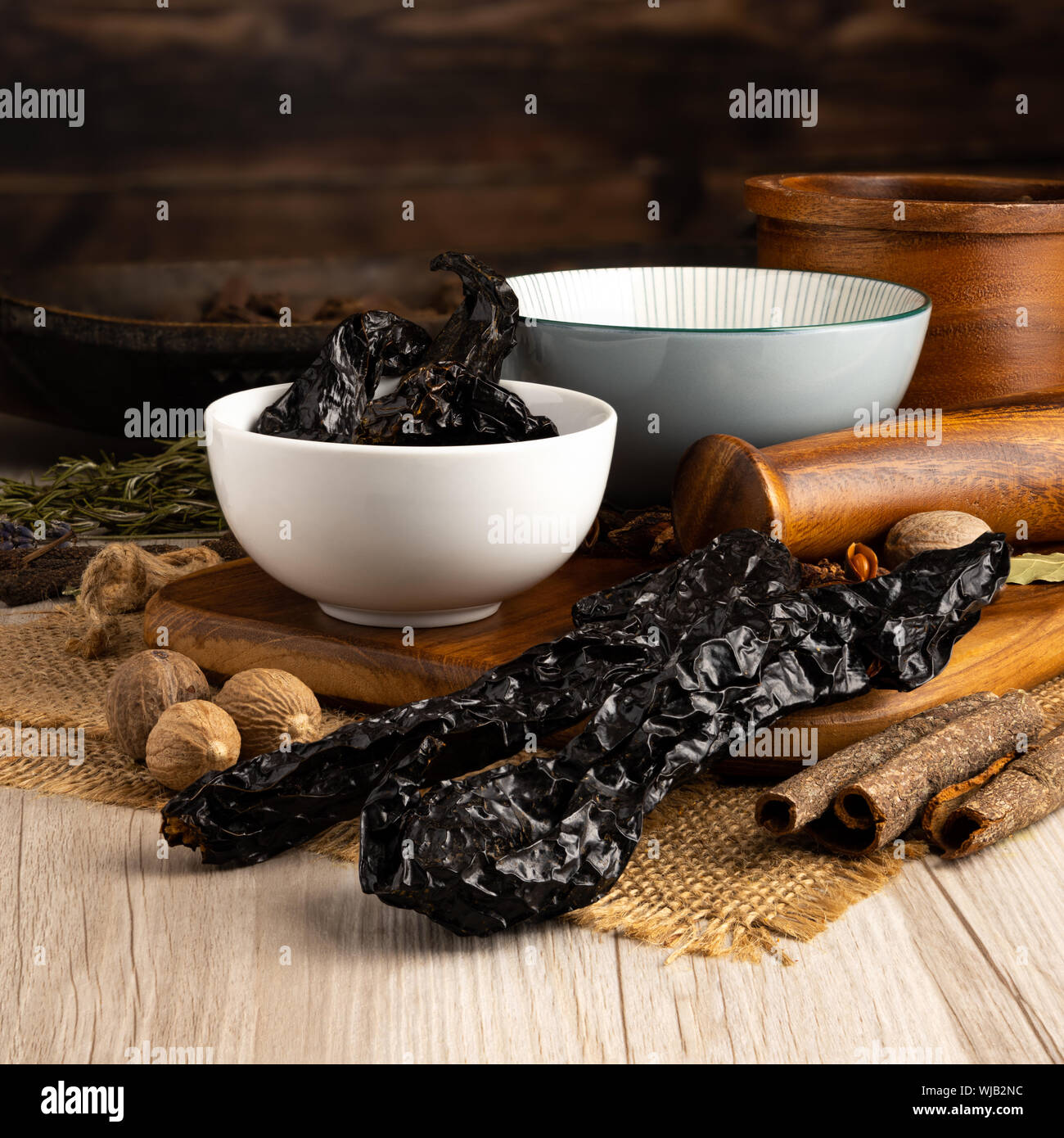 Dry Mexican Pasilla Chilli Chile Pods in a bowl with a kitchen setting ...