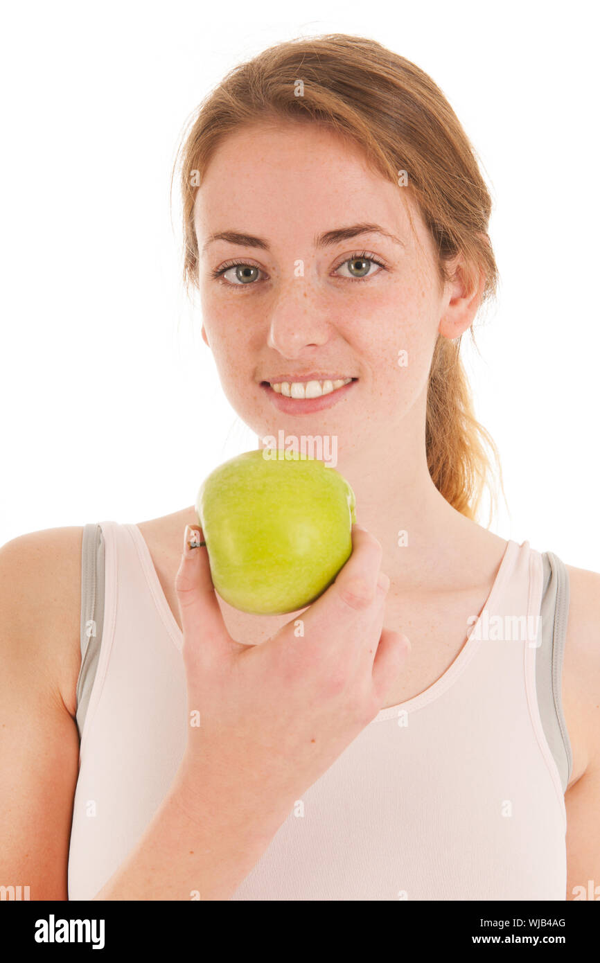 Sport woman is eating an apple isolated over white background Stock ...