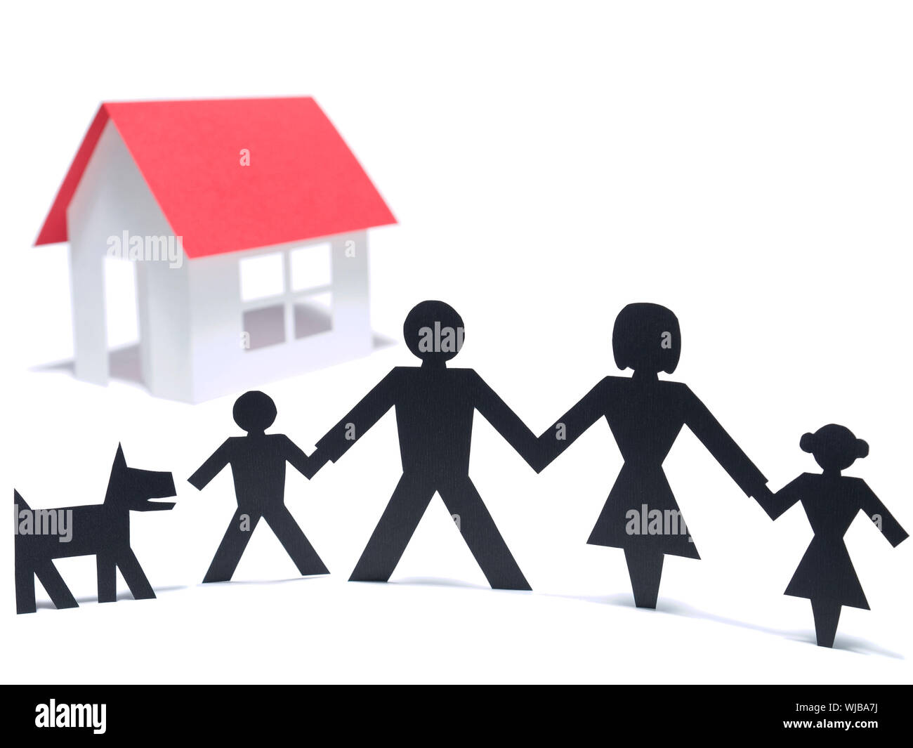 A paper family is holding hands beside their new paper house. Even the ...