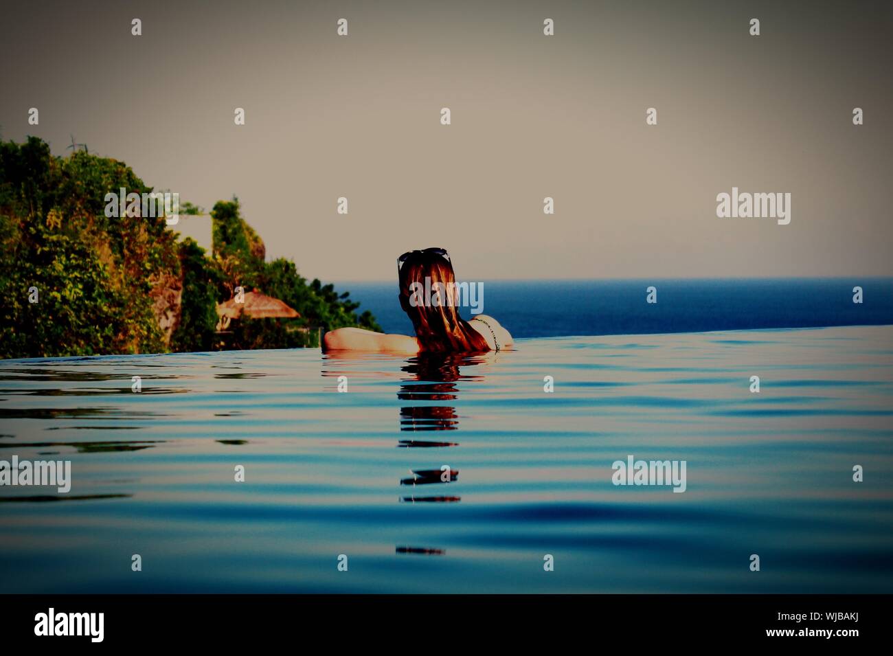 Woman overlooking pool hi-res stock photography and images - Alamy