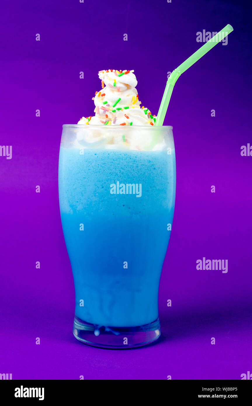 Icy blue milk shake on purple background Stock Photo - Alamy