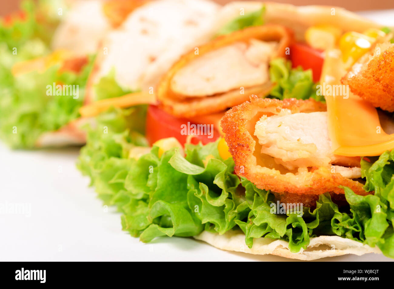 Selective focus on the right chicken meat wrap Stock Photo - Alamy