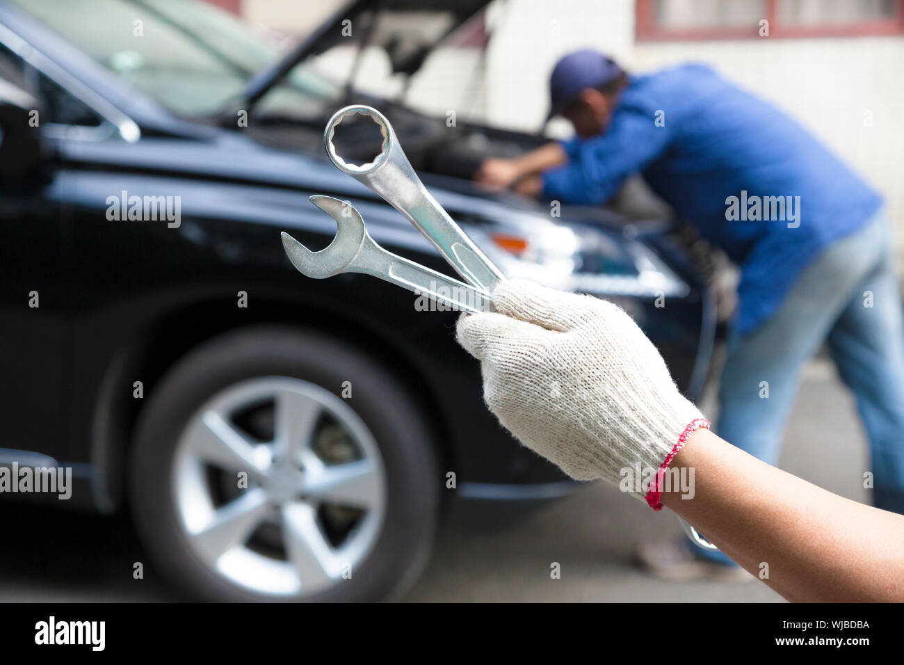 hand holding tools and car service concept Stock Photo - Alamy