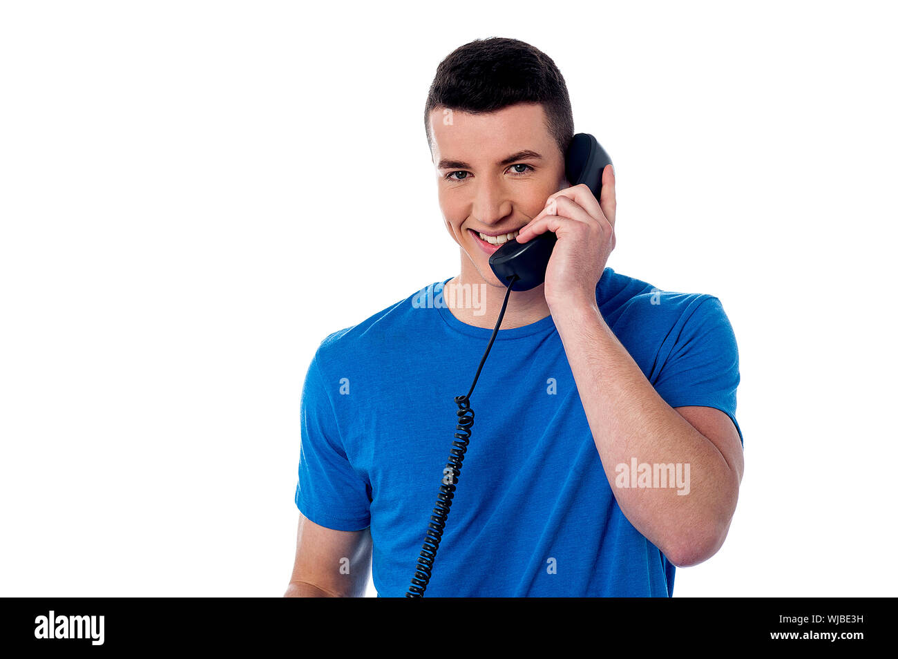 Young man answering the phone call Stock Photo - Alamy