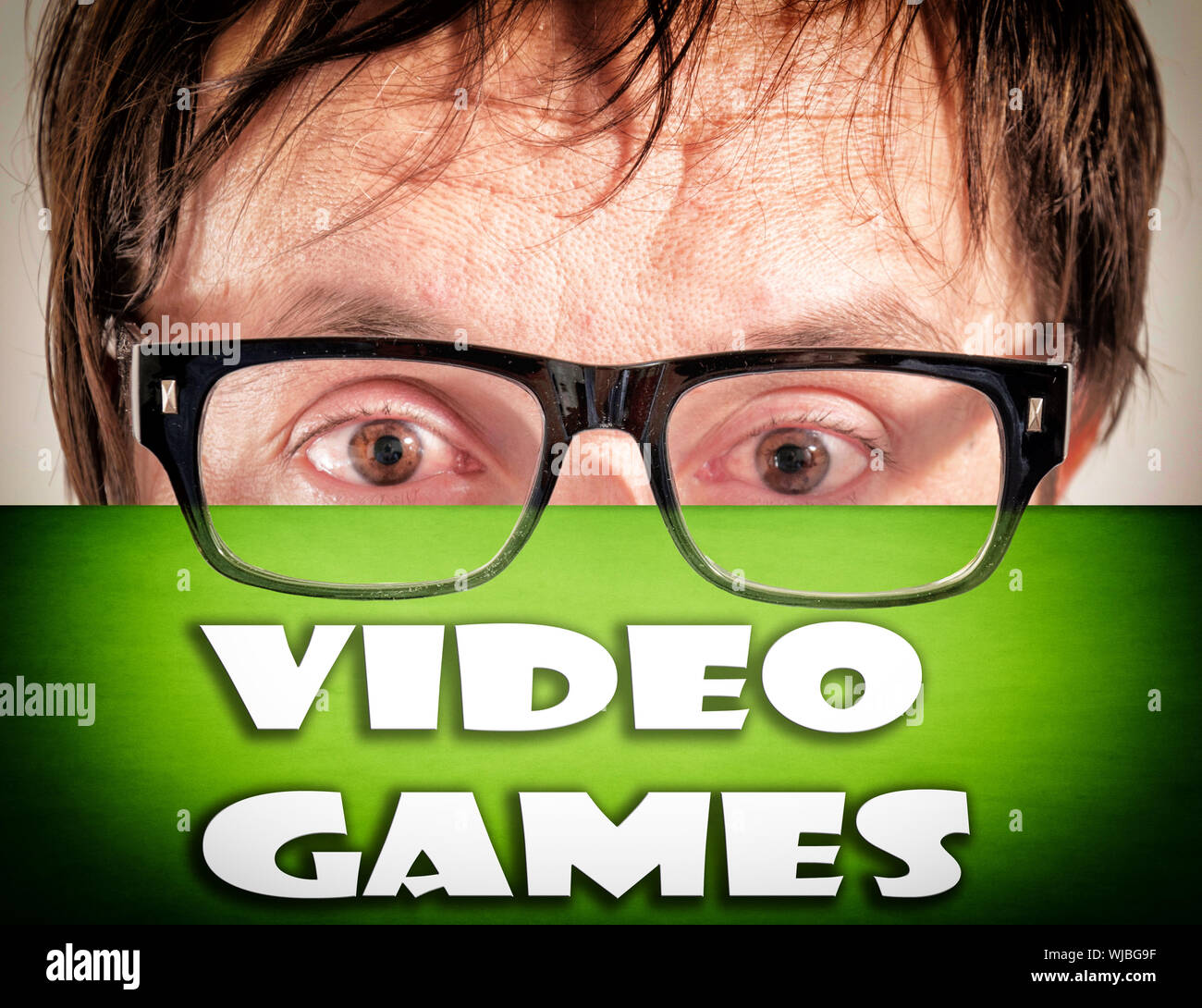 Man holding video games over his face Stock Photo - Alamy