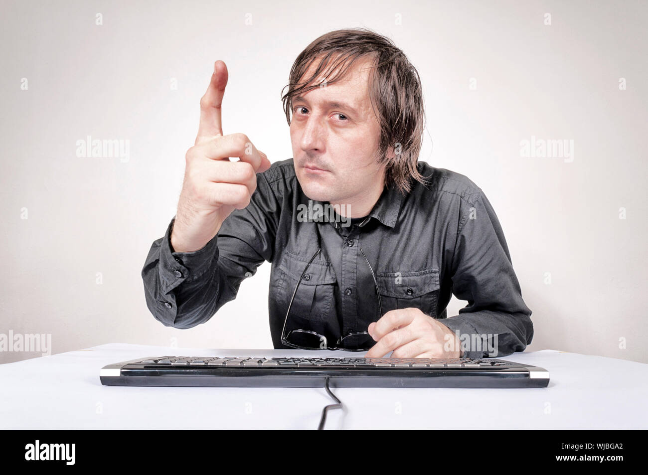 Serious man showing warning sign with his hand Stock Photo - Alamy