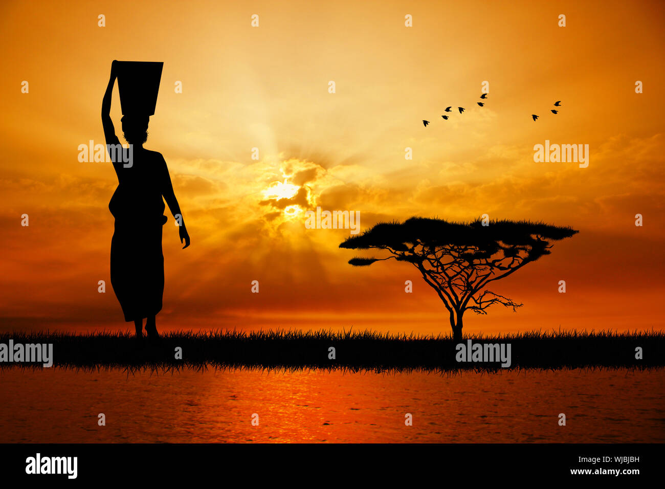 African woman at sunset Stock Photo - Alamy