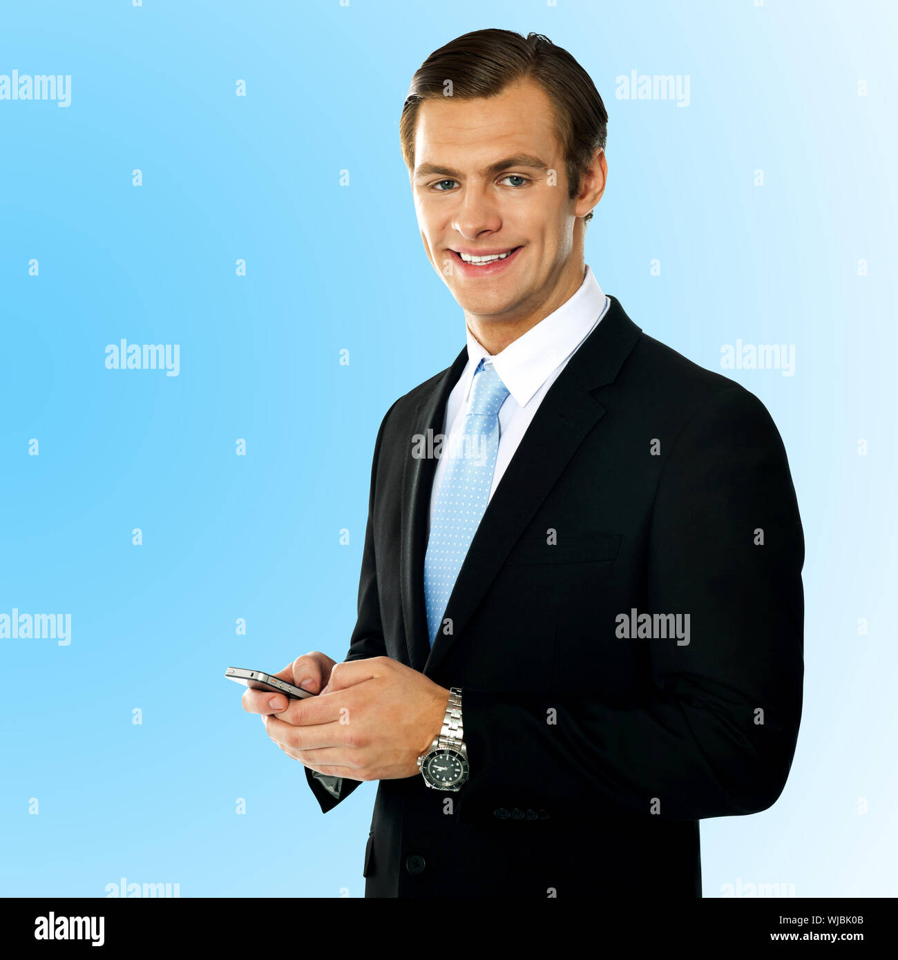 Corporate guy sending text message Stock Photo - Alamy