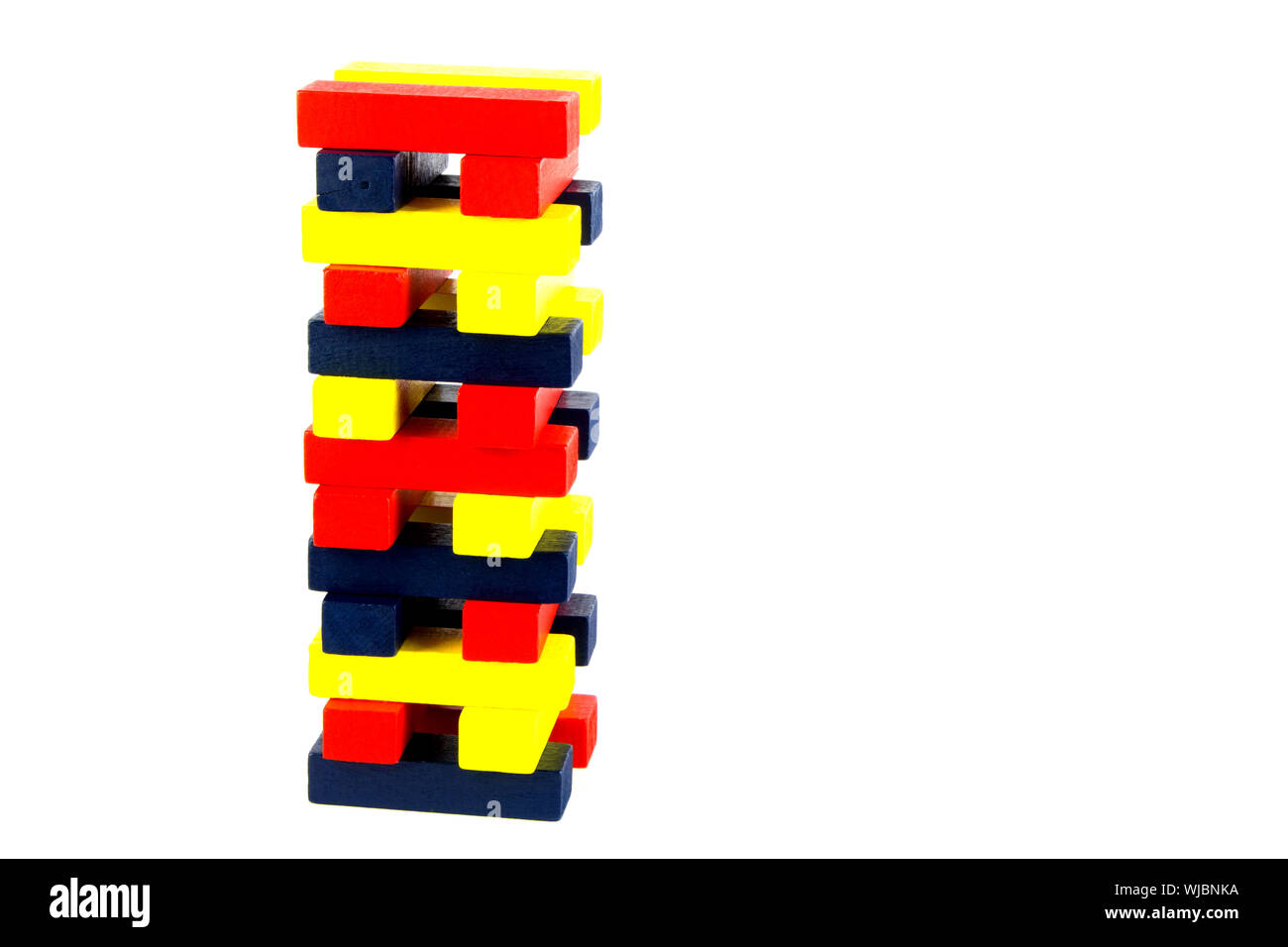Stacked coloured wooden play blocks isolated on a white background ...