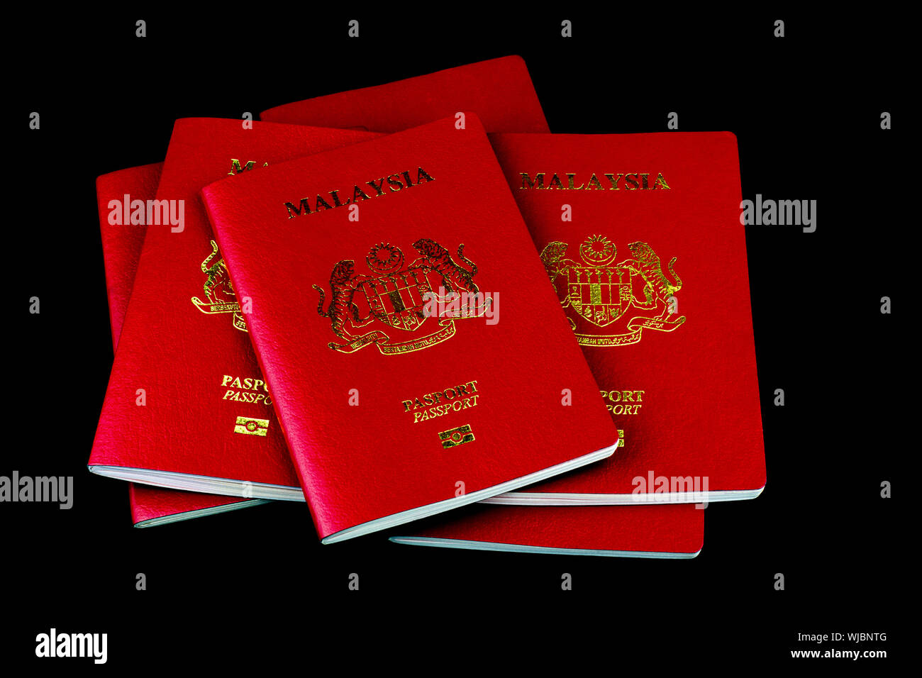 A stack of Malaysian passports isolated on a black background Stock ...