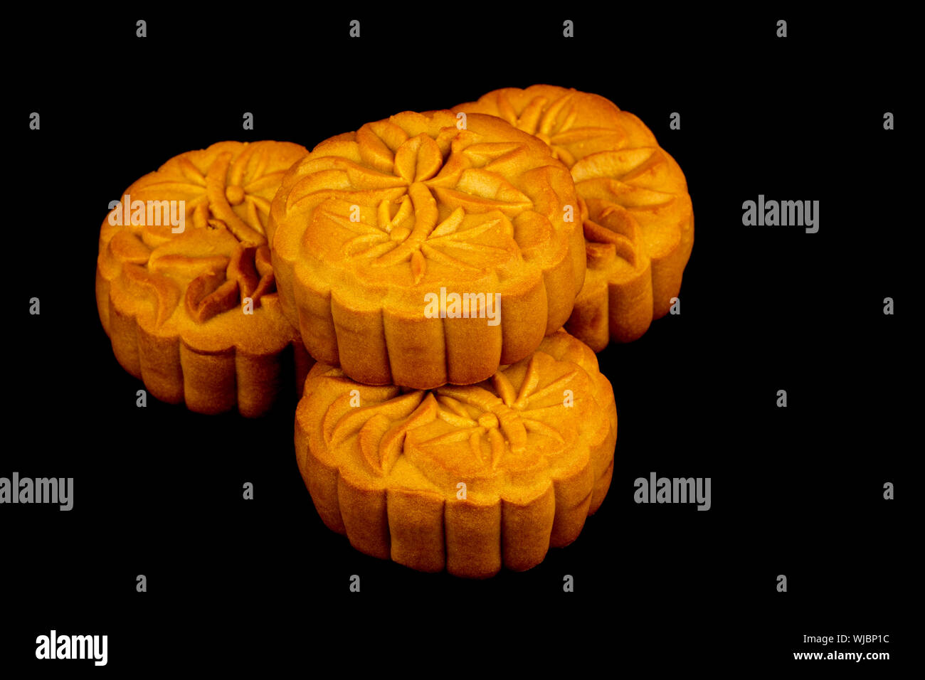 Traditional Chinese mooncakes isolated against a black background Stock ...