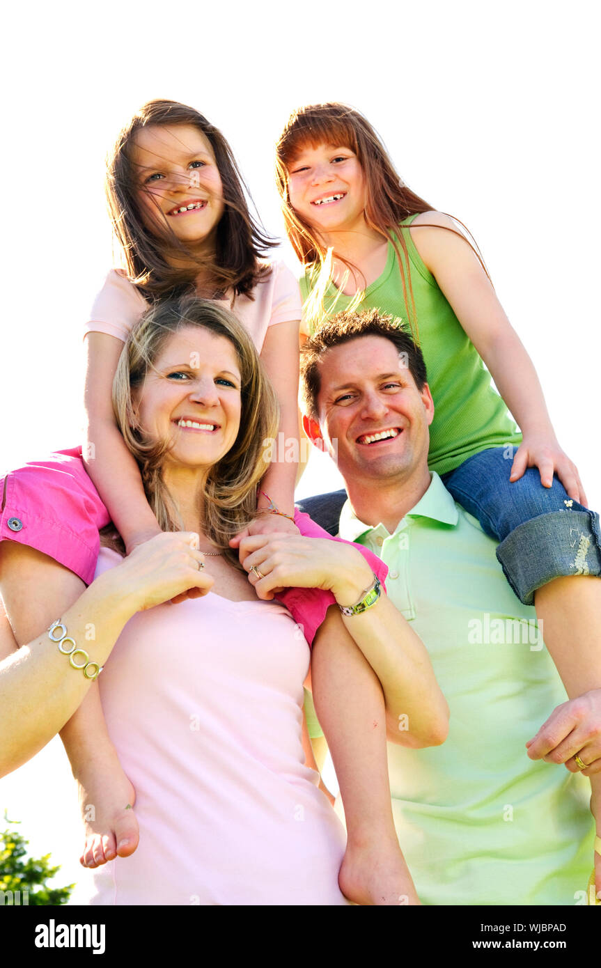Portrait of happy family giving children shoulder rides Stock Photo - Alamy