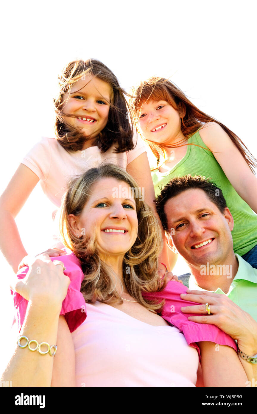 Portrait of happy family giving children shoulder rides Stock Photo - Alamy