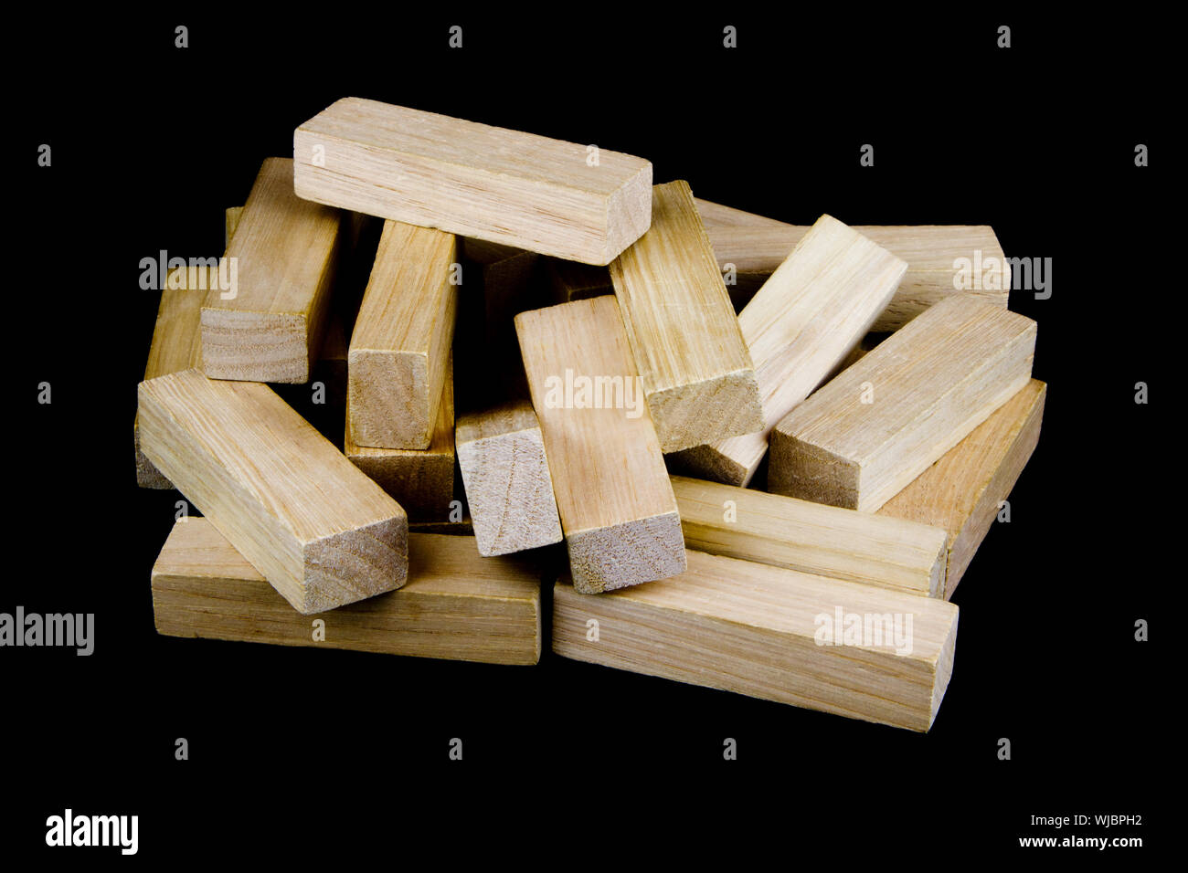Pile of wooden play blocks isolated on black background Stock Photo - Alamy