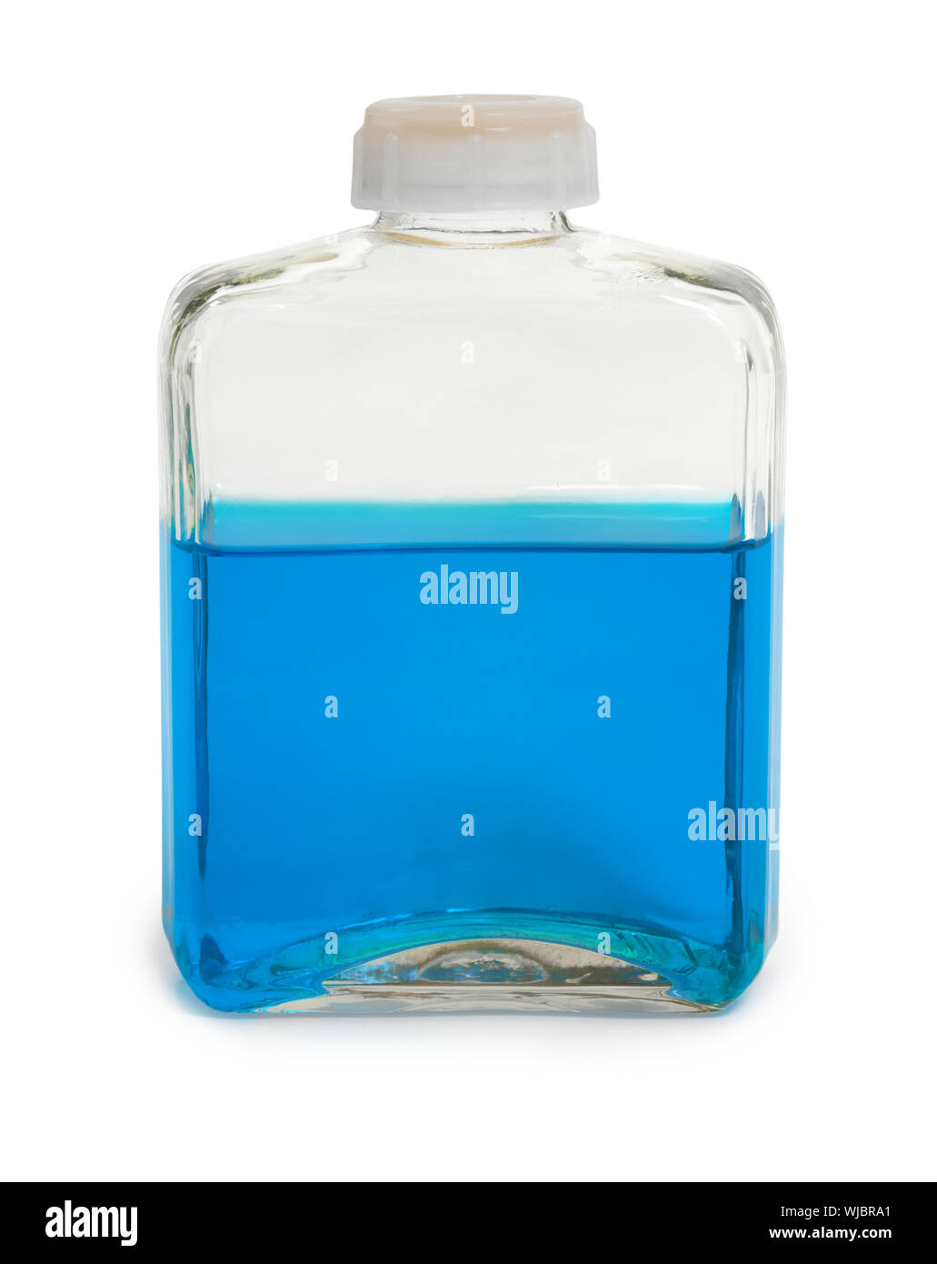 Glass bottle filled with a dark blue chemical solution Stock Photo - Alamy