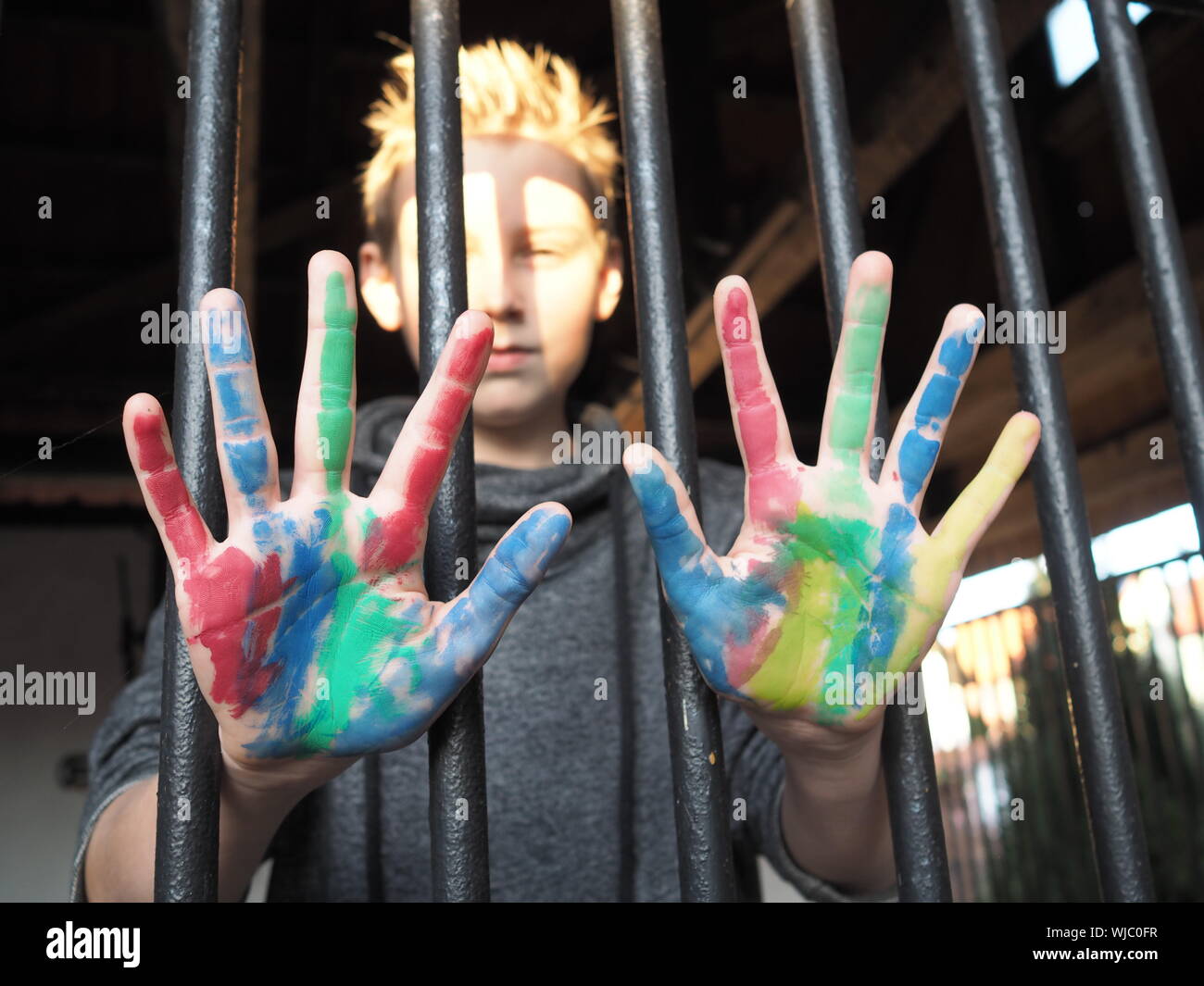 Boy behind the fence hi-res stock photography and images - Alamy