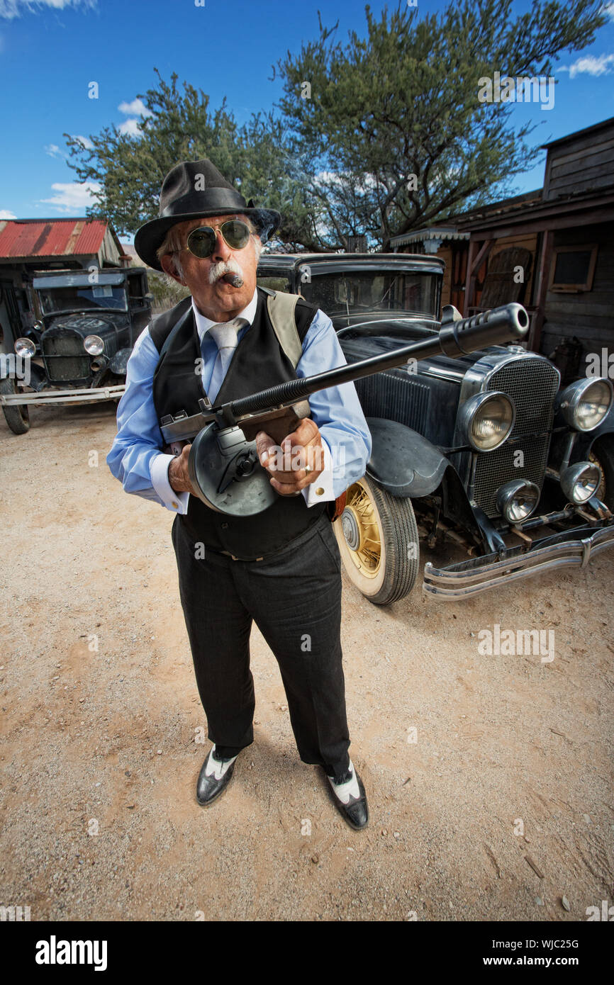 Male gangster with sunglasses, cigar and machine gun outdoors Stock ...