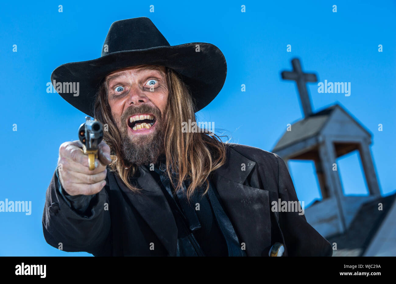 Laughing Cowboy With Gun Stock Photo - Alamy