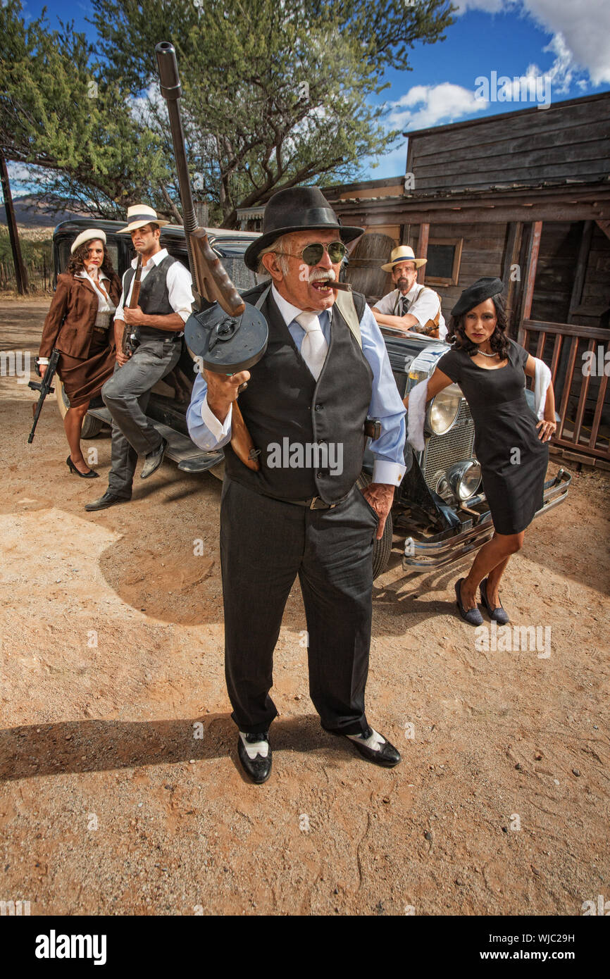 Tough middle aged criminal with gang outside Stock Photo - Alamy