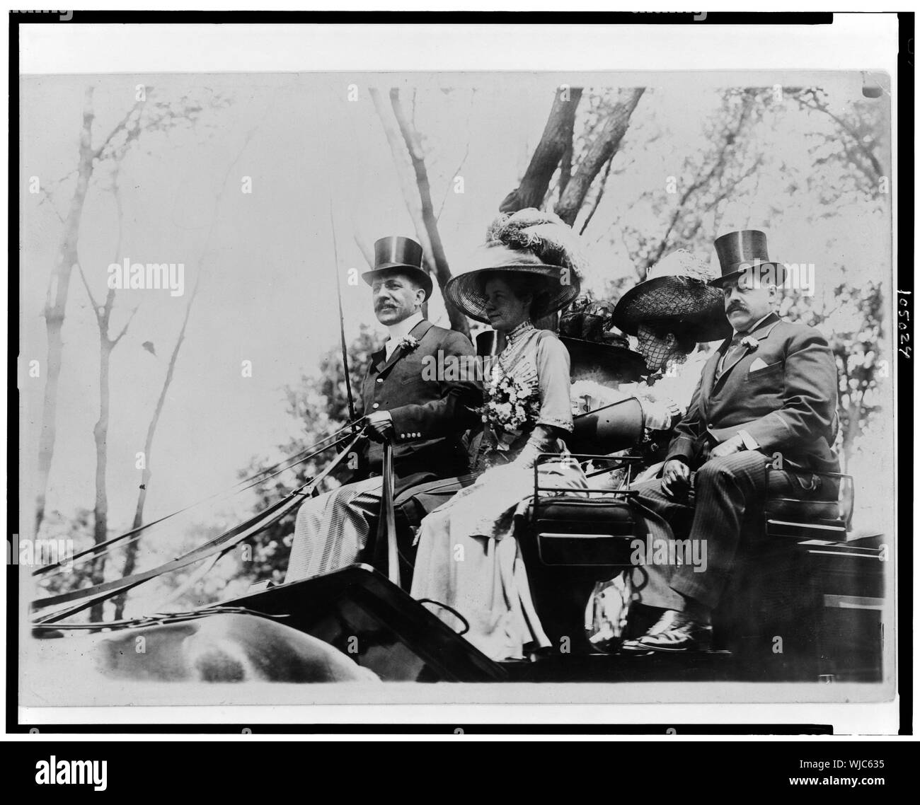 Harris Charles Fahnestock seated in carriage next to woman in plumed ...