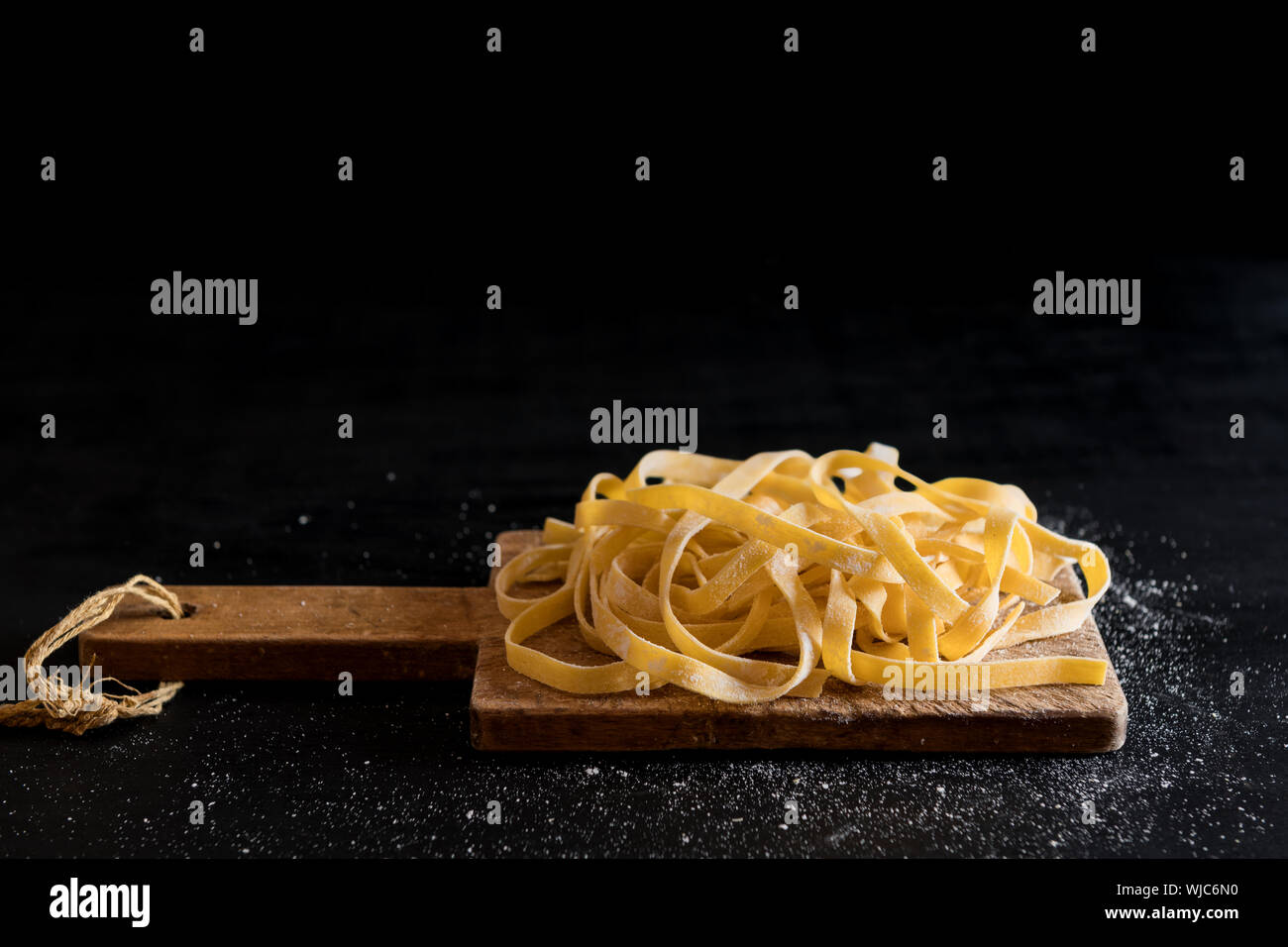 A variety of Italian homemade raw uncooked tagliatelle pasta on a ...