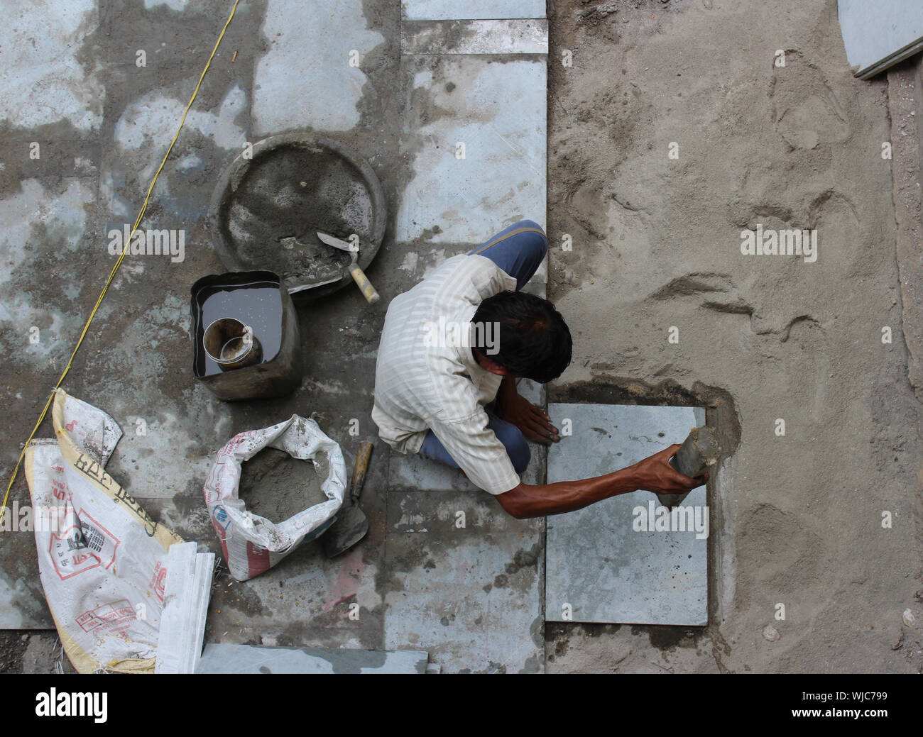 Mason fixing tiles hi-res stock photography and images - Alamy