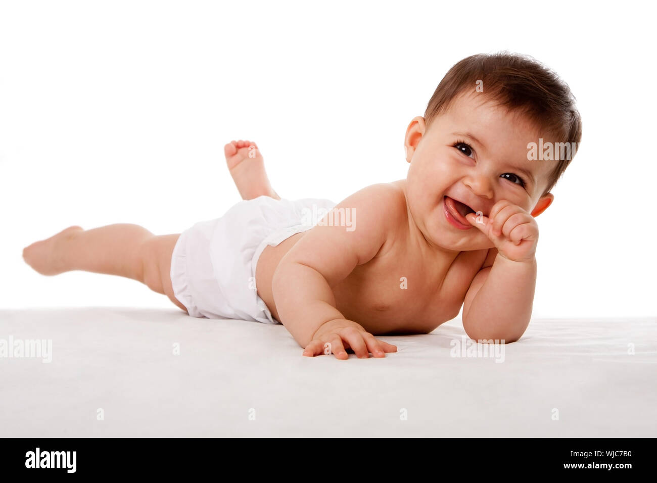 Happy cute baby laying Stock Photo - Alamy