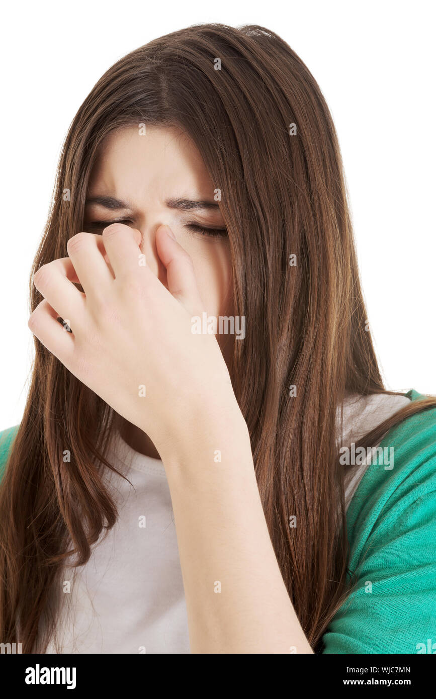 Young beautiful woman with sinus pressure, touching her nose. Isolated ...