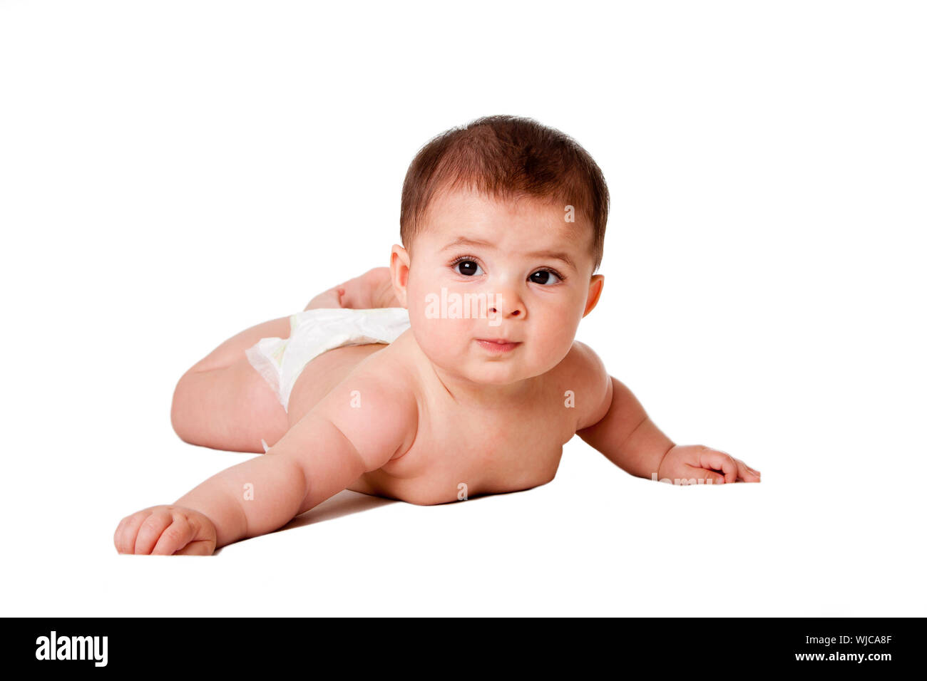 Beautiful cute happy Caucasian Hispanic baby infant laying on belly ...