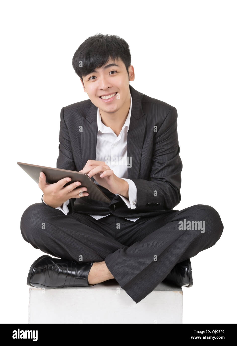 Asian businessman use pad sit on ground, full length portrait isolated ...