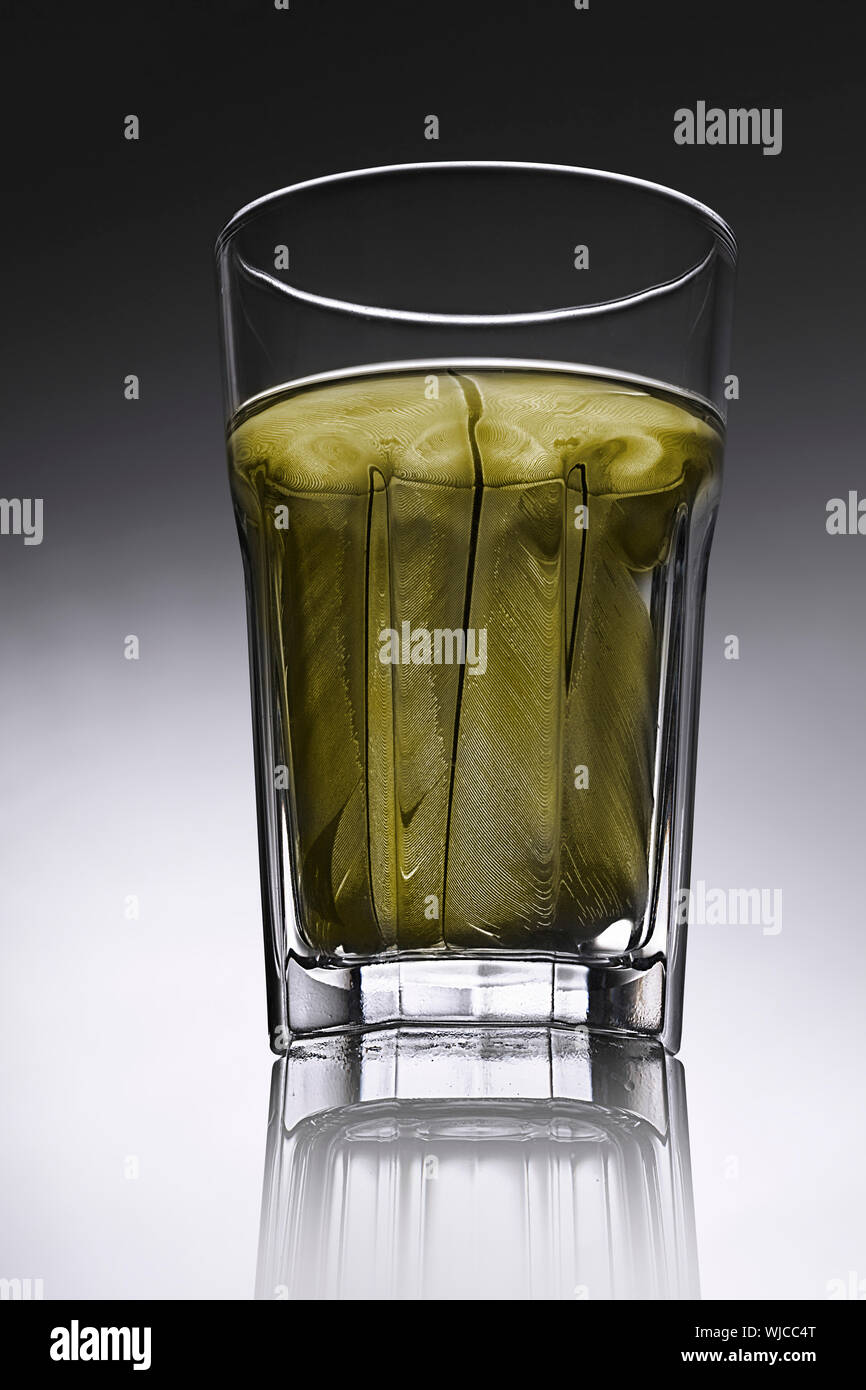 simple water-glass with structured water in yellow Stock Photo - Alamy