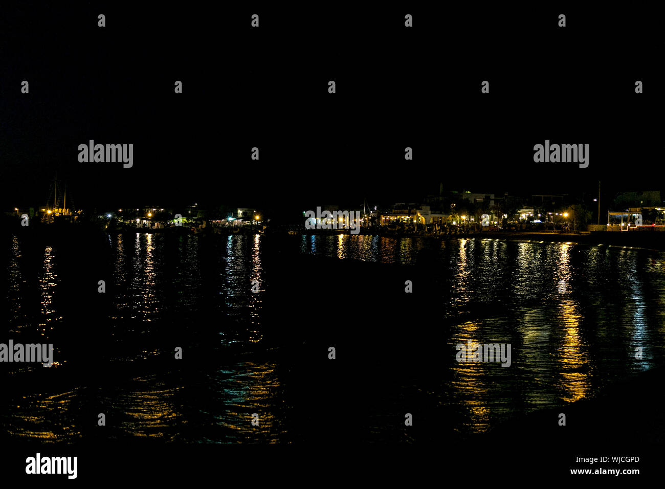 night shoot of a bay with reflecting light in the ocean Stock Photo - Alamy