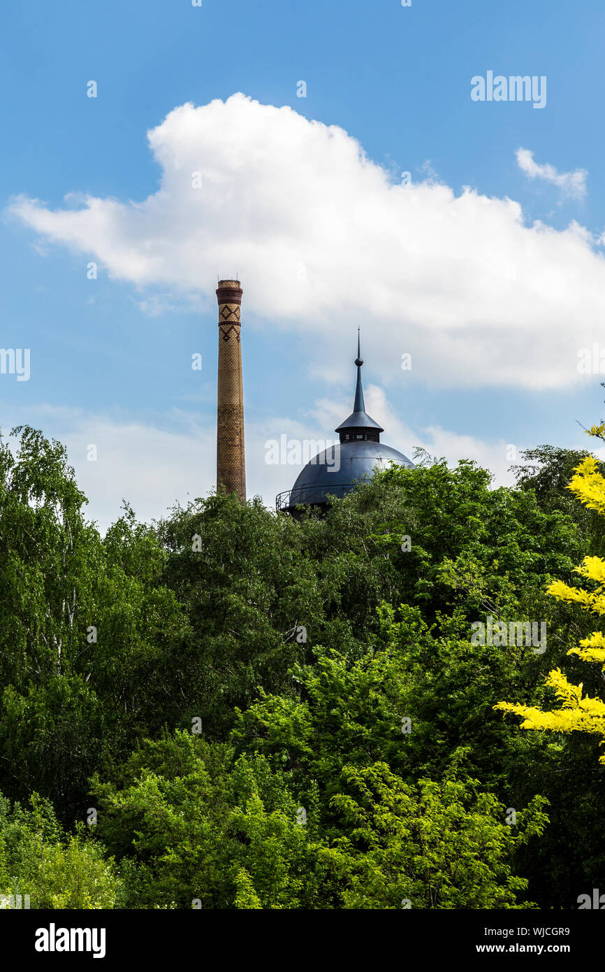 vintage chimney and water tank behind a forest Stock Photo - Alamy