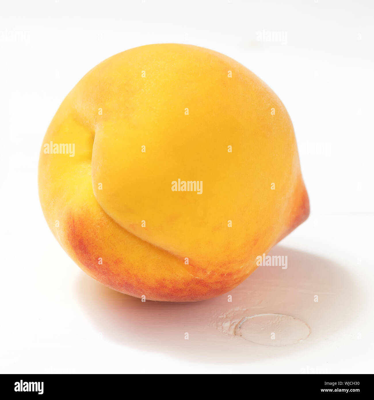 Yellow italian fresh peach percoche on the white wooden background with ...