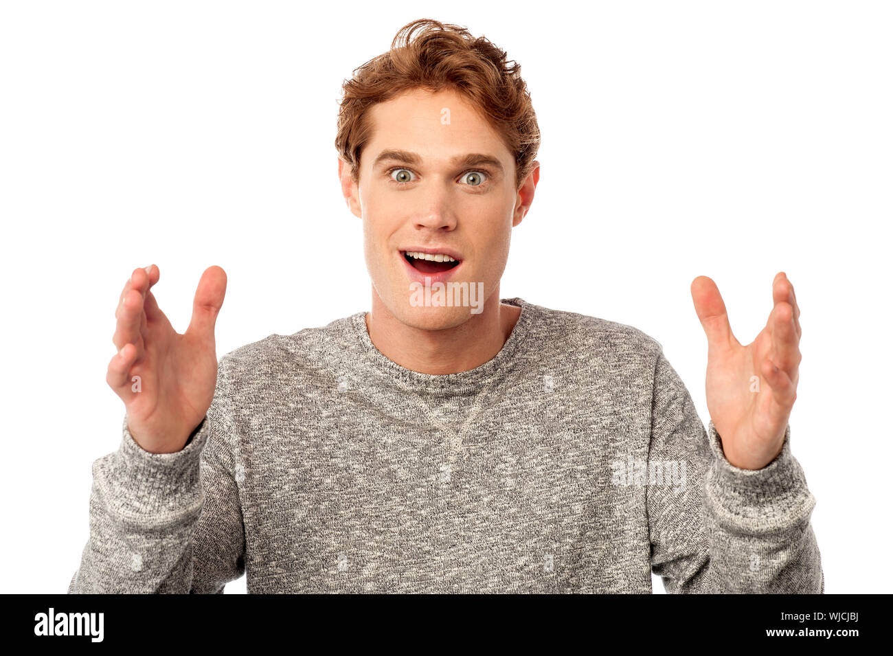 Shocked young excited guy over white Stock Photo - Alamy