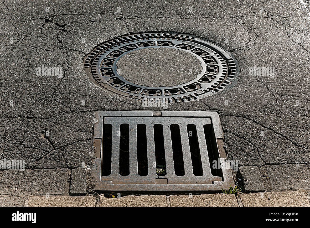 vintage style photo of two gully covers Stock Photo - Alamy