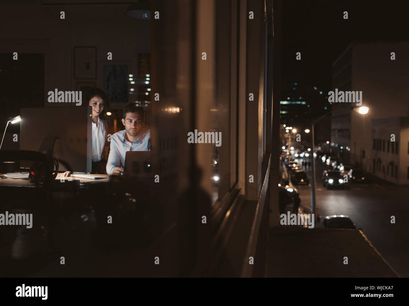 Woman working late in dark office hi-res stock photography and images ...