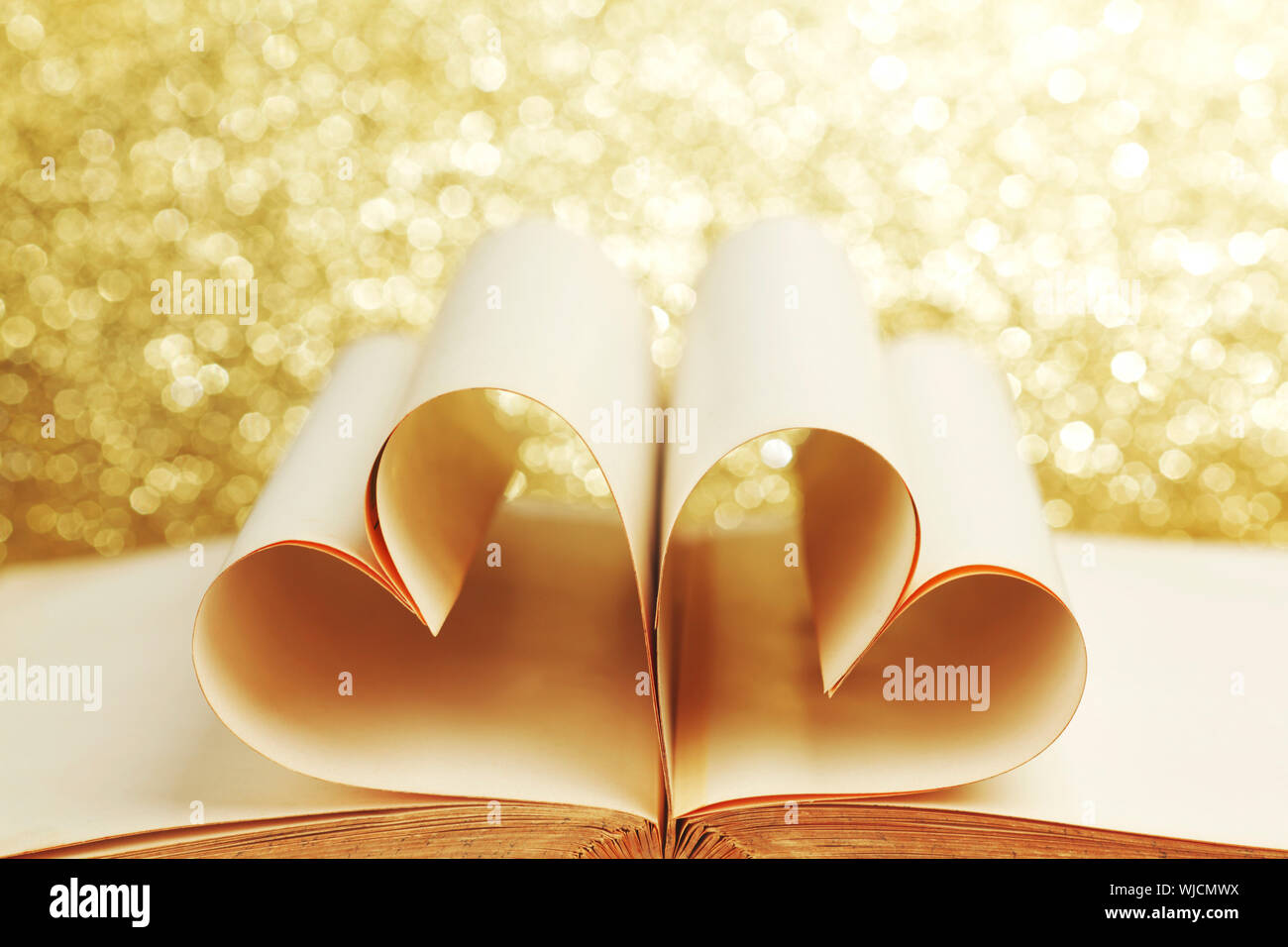 Heart made of blank pages inside a book on glitter background Stock ...