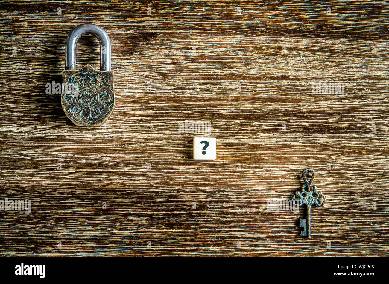Old vintage padlock and key with question mark on wooden texture Stock ...