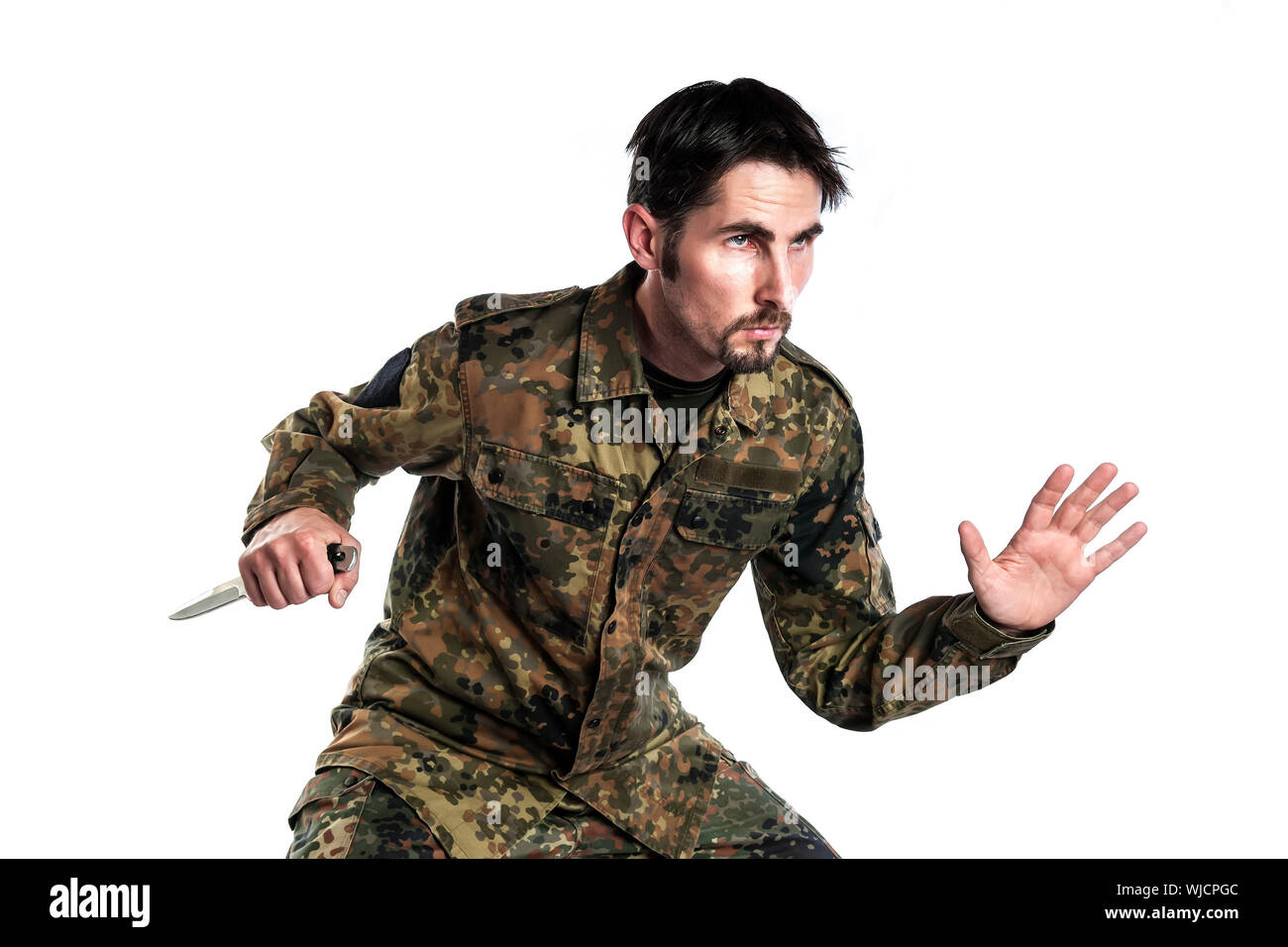 Male self defense instructor with camouflage do a self defense exercise ...