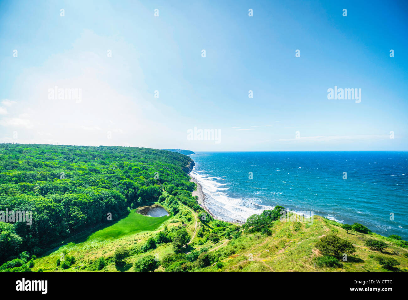 Ocean view over a valley by the sea with green forest and meadows Stock ...