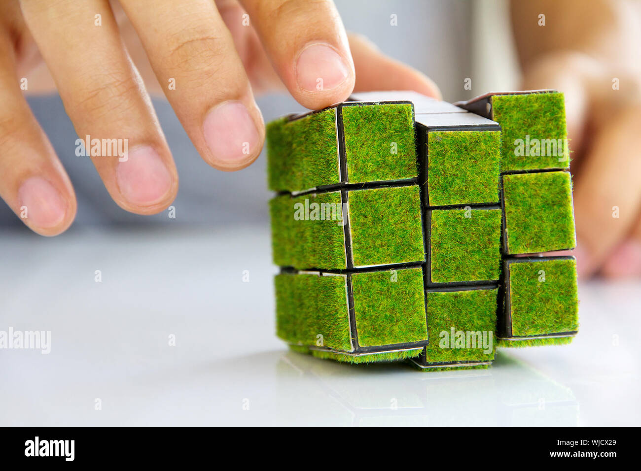 hand holding green rubik's cube concept Stock Photo - Alamy