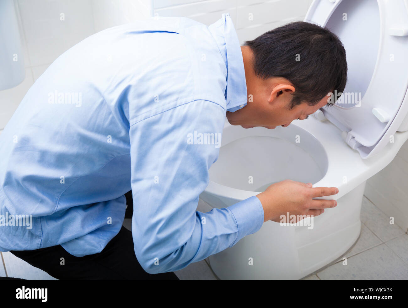 Man vomiting toilet hi-res stock photography and images - Alamy