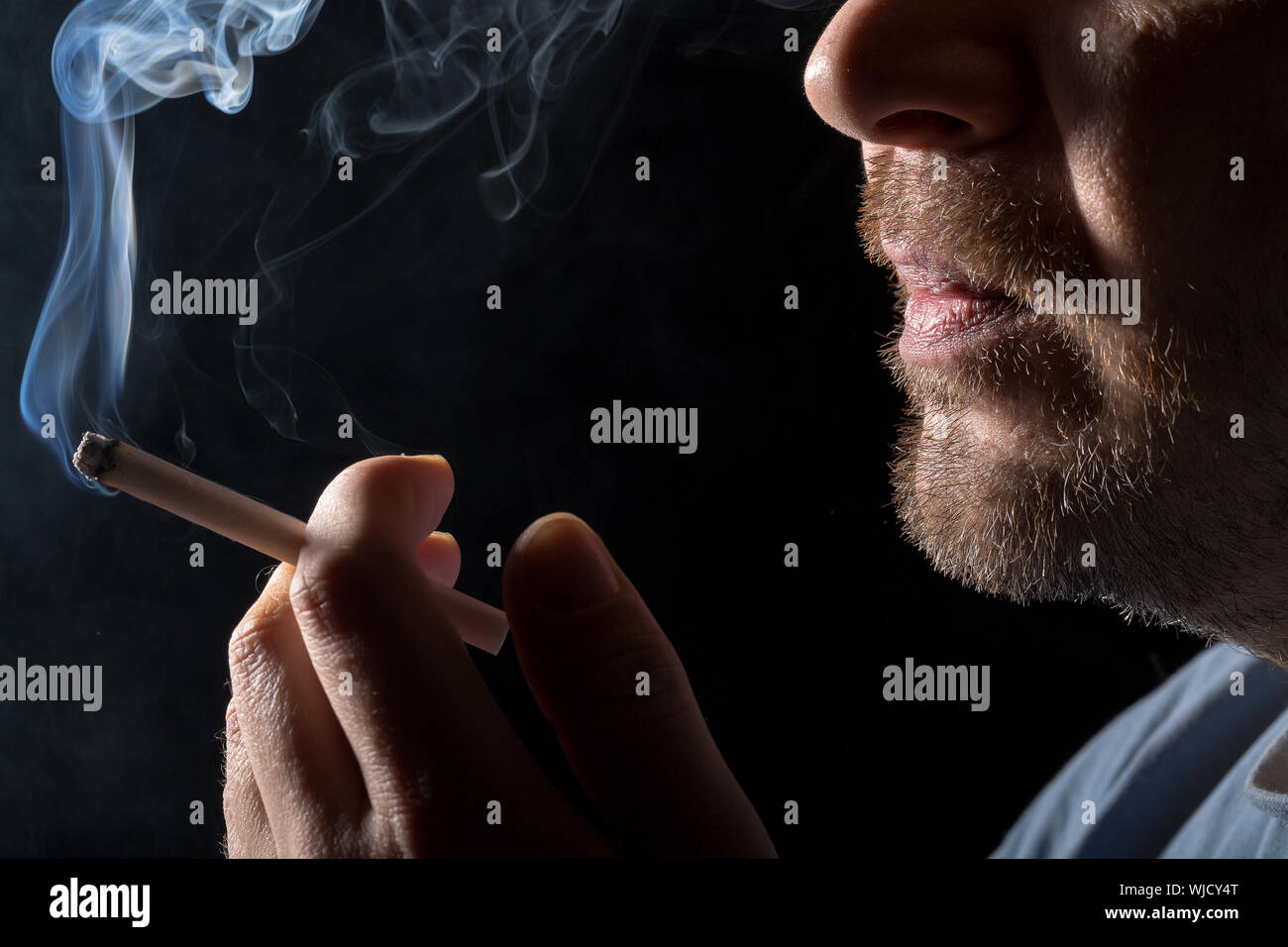 Portrait man smoking cigarette, closeup on black background Stock Photo ...