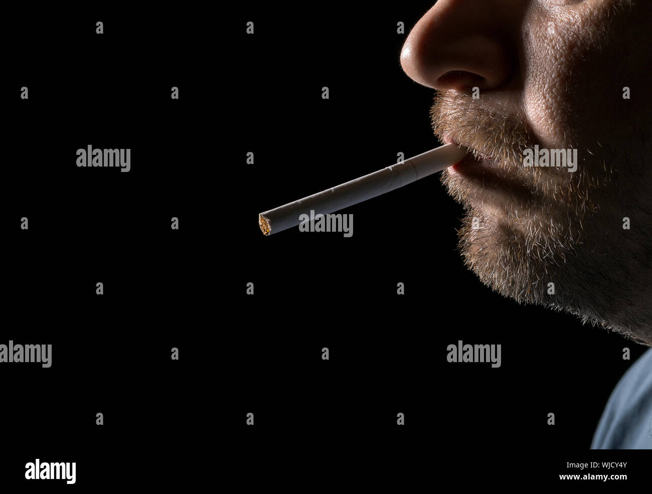 Portrait man smoking cigarette, closeup on black background Stock Photo ...