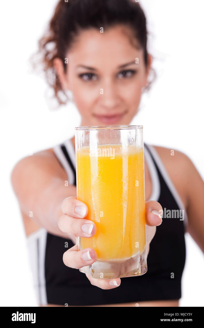 fitness girl holding a fresh juice,focus on juice on a white isolated ...