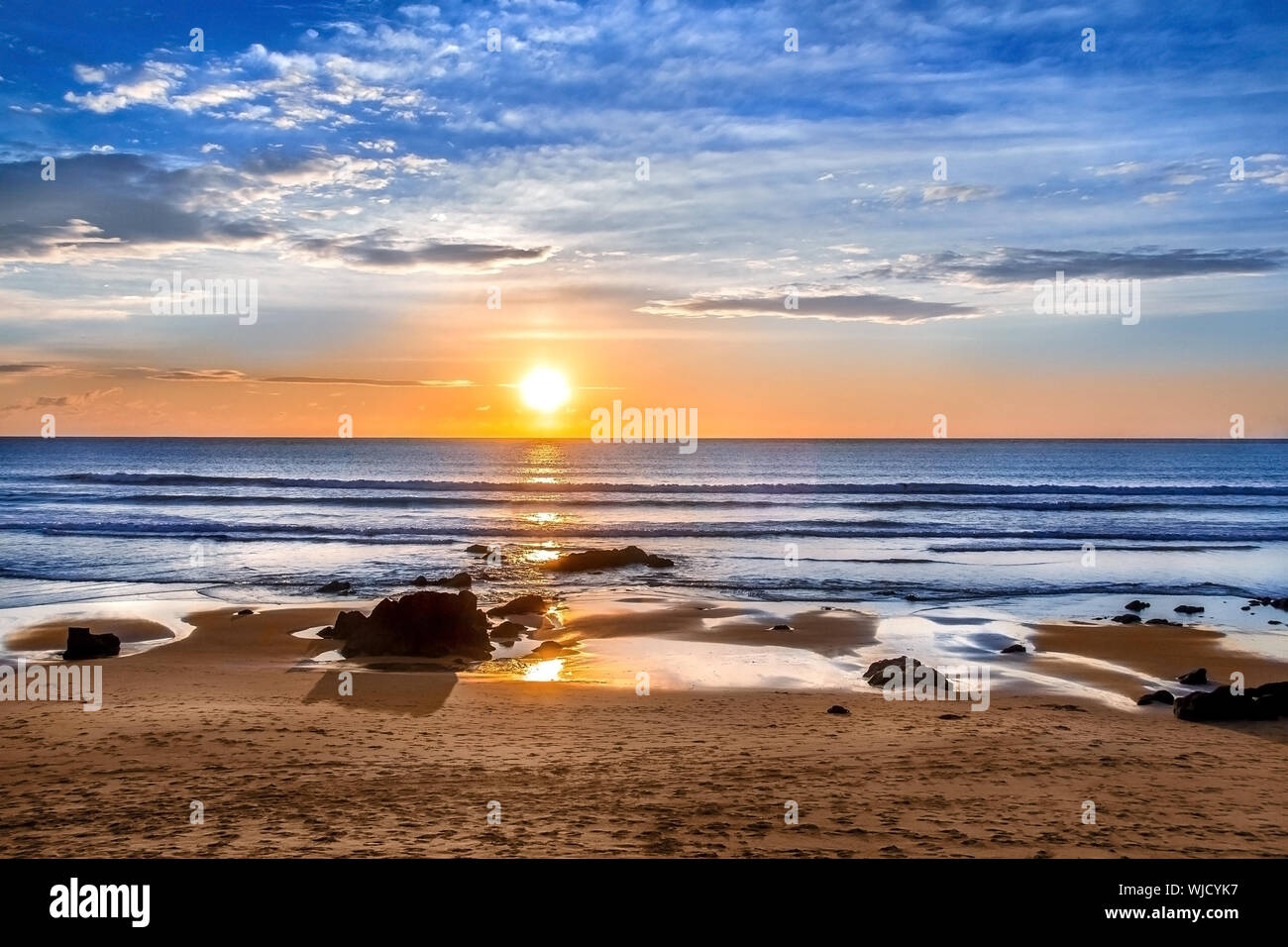 Beautiful late afternoon sunset at the beach Stock Photo - Alamy