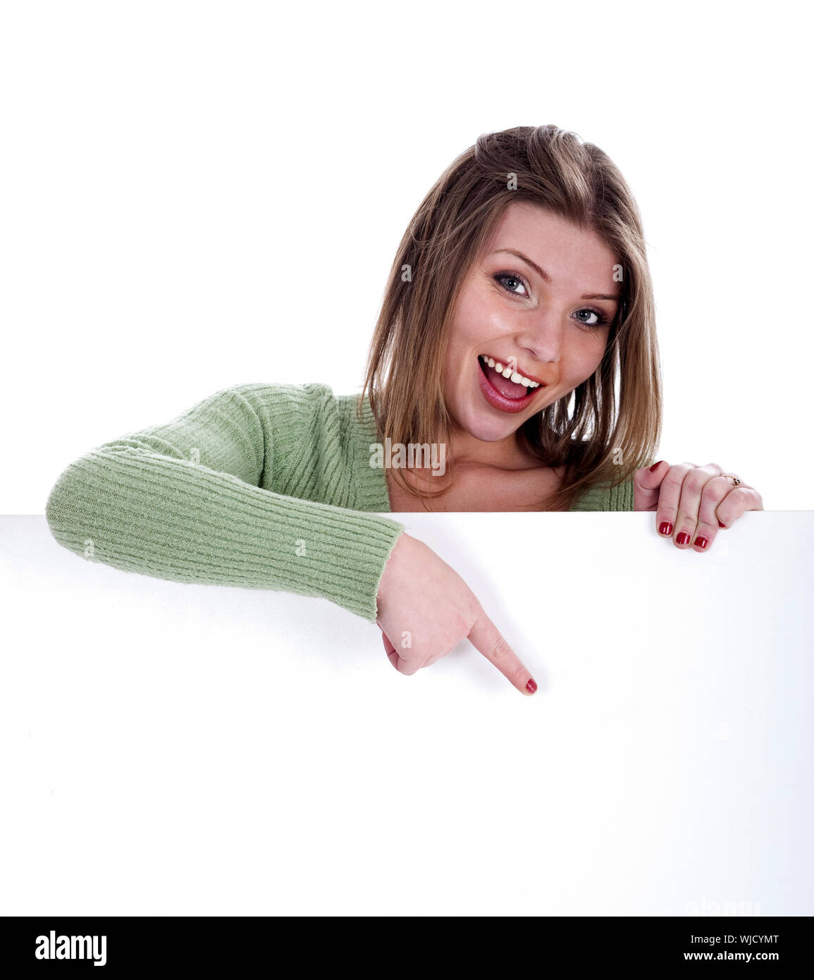 Happy beautiful woman pointing out the blank white board over white ...